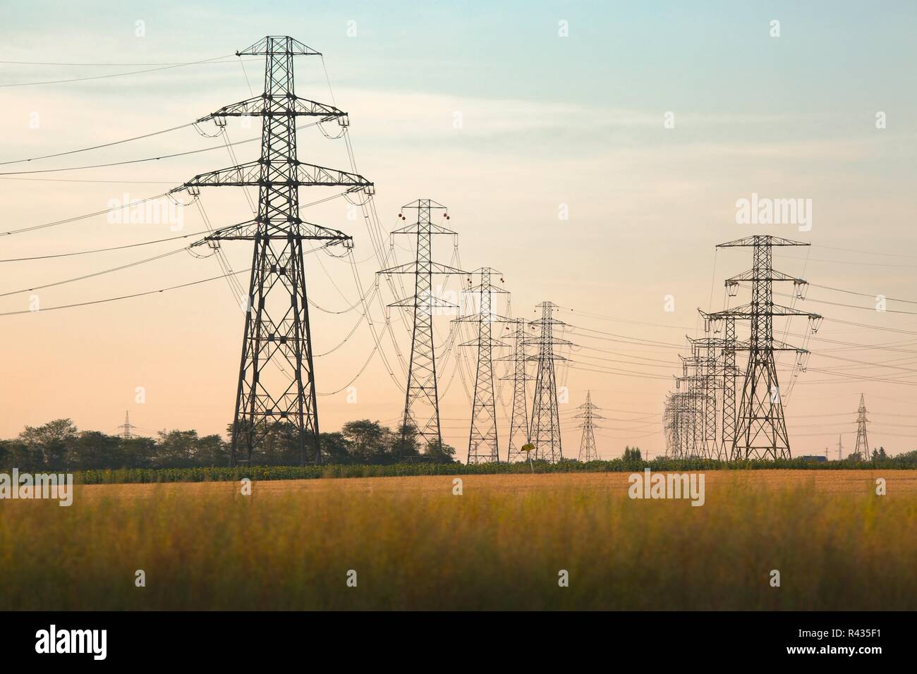 Electric lines on land Stock Photo - Alamy