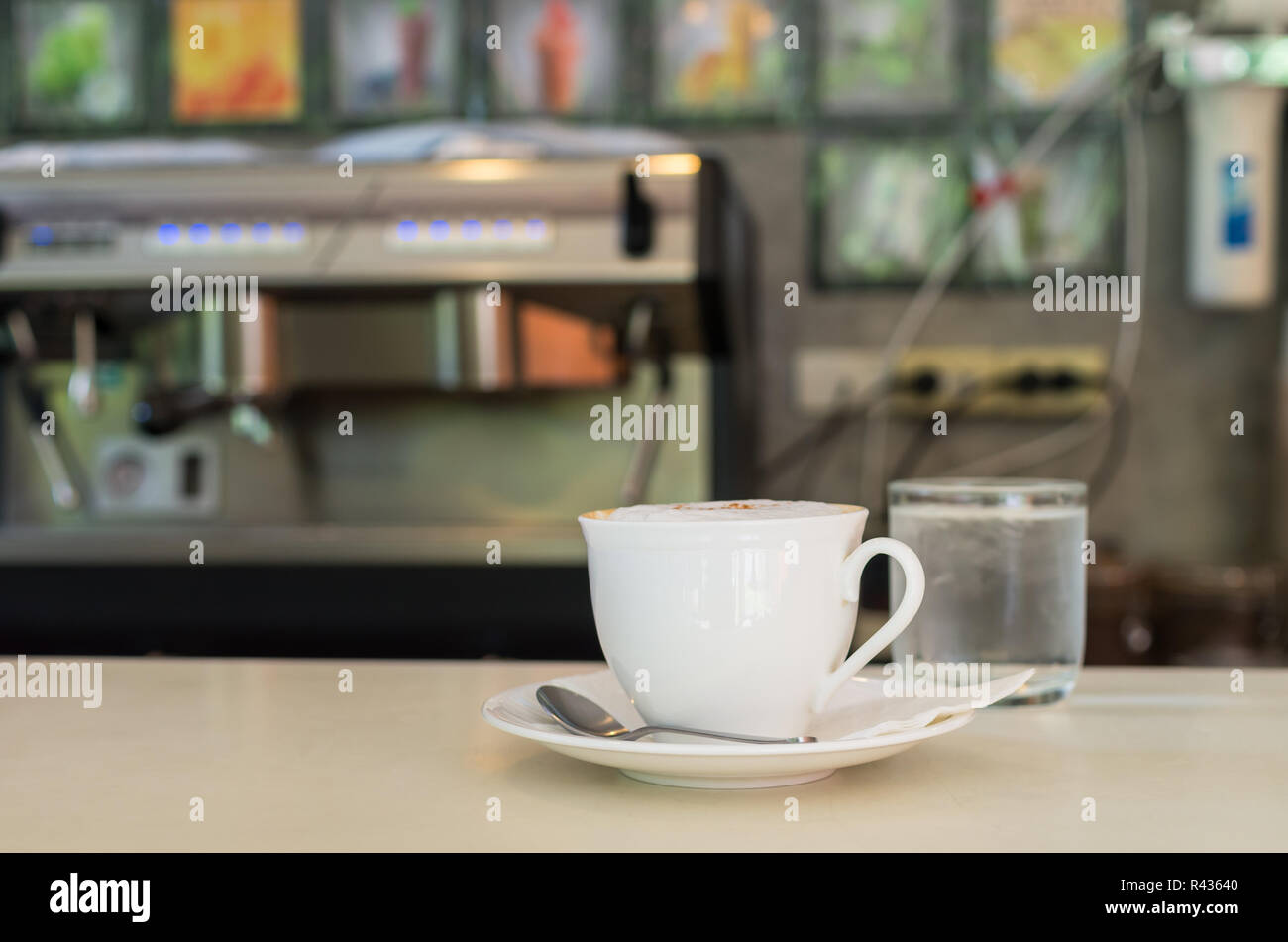 Coffee cup on machine blur background Stock Photo - Alamy