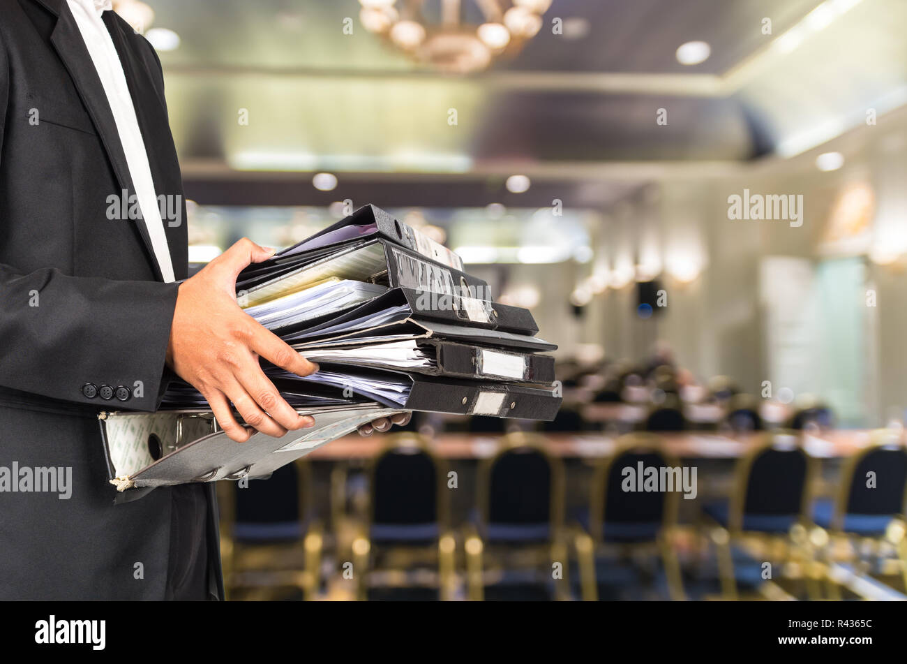 Businessman is holding many document folders on Abstract blurred photo ...