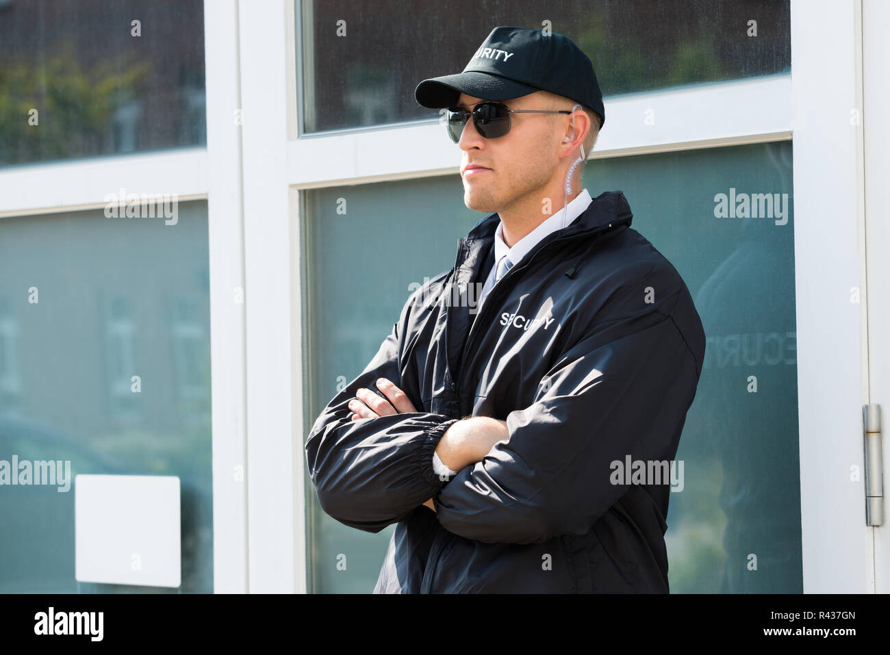 Male Security Guard Standing At The Entrance Stock Photo - Alamy