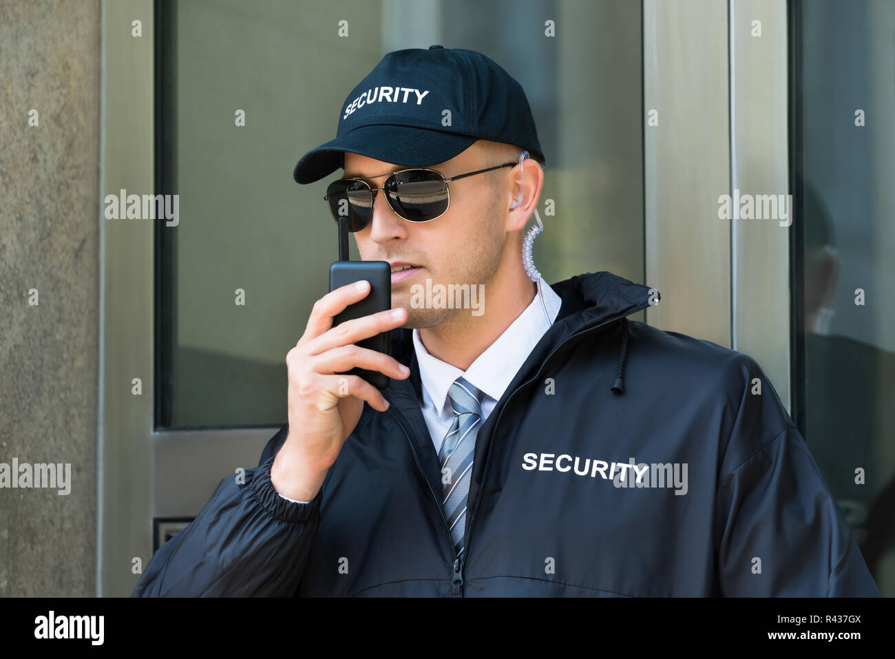 Security Guard Using Walkie-talkie Radio Stock Photo - Alamy