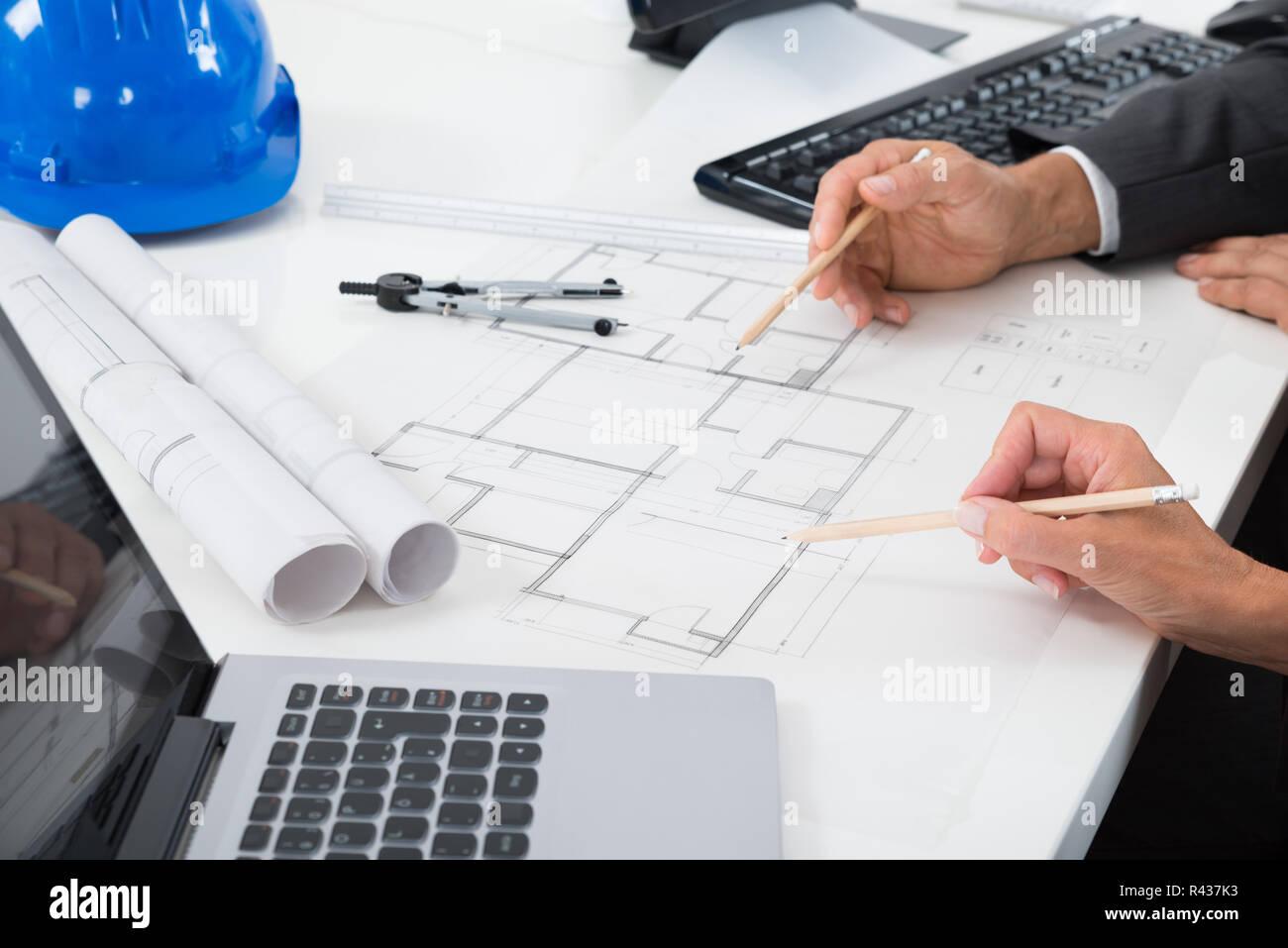 Two Architects Working On Blueprint Stock Photo - Alamy