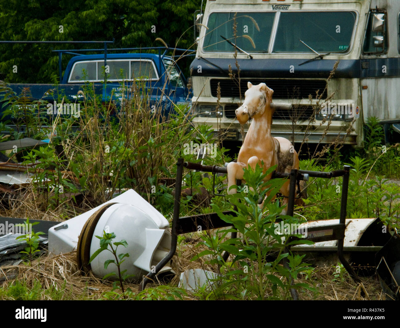 An array of discarded objects at a junkyard, including a rocking horse ...