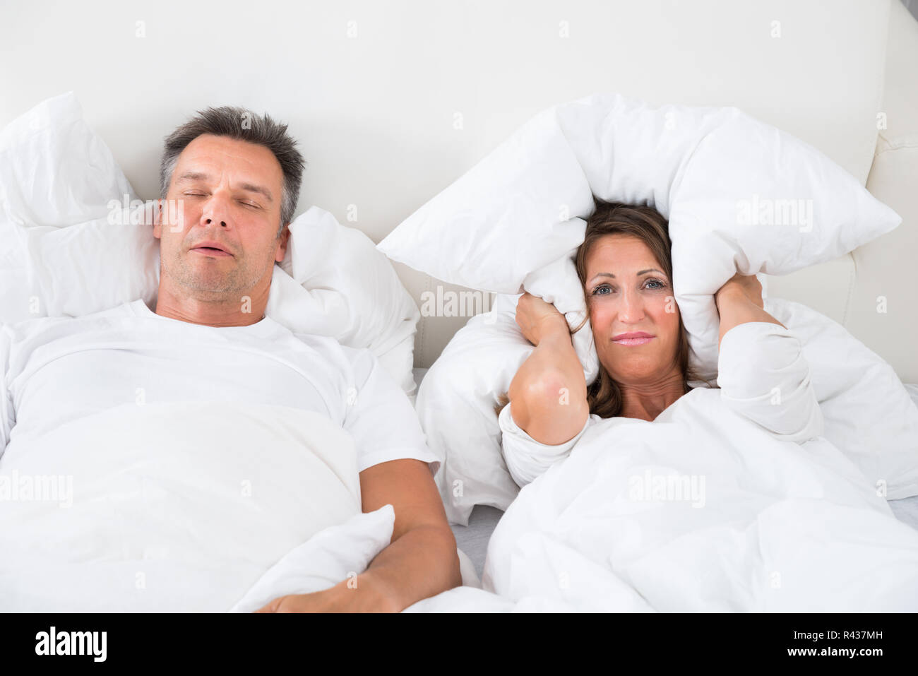 Angry Woman Trying To Sleep With Snoring Man Stock Photo - Alamy