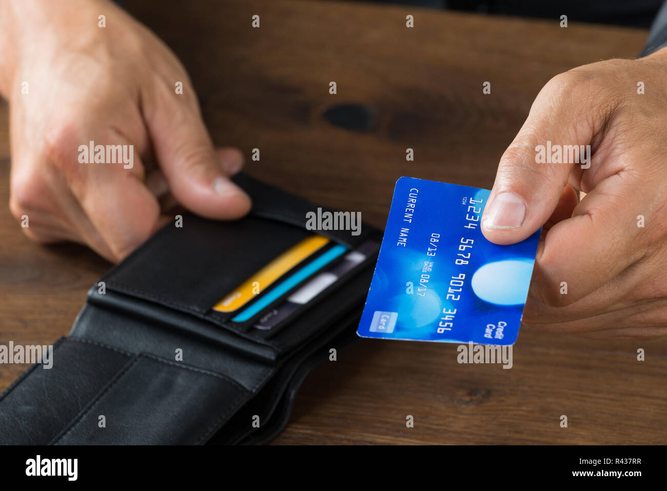 Businessman Giving Credit Card From Wallet Stock Photo - Alamy