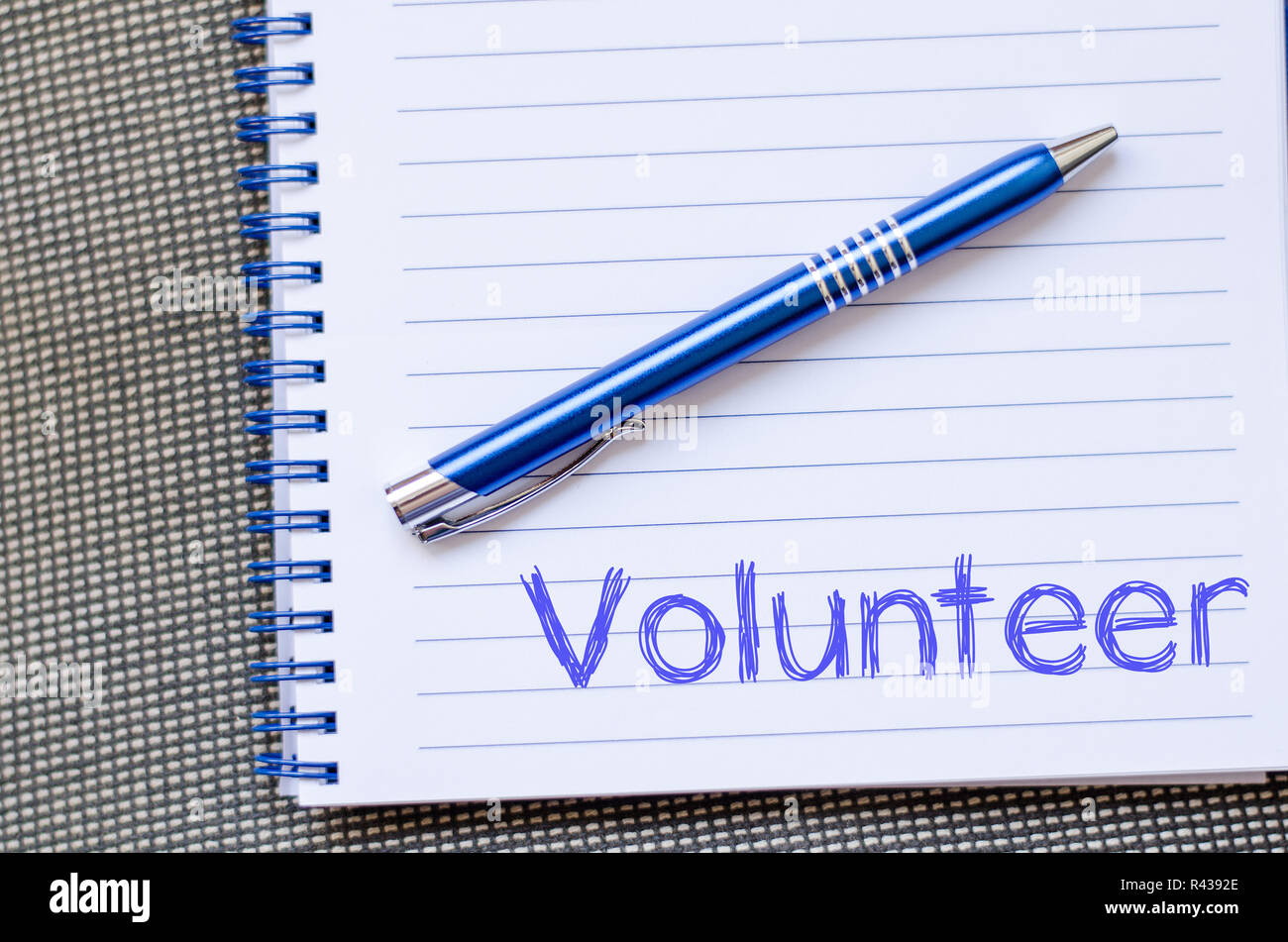Volunteer write on notebook Stock Photo - Alamy