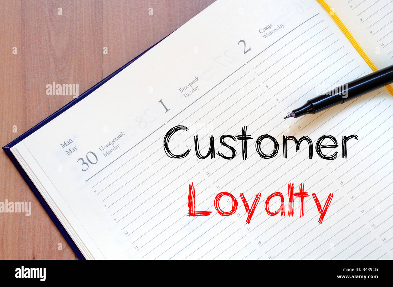 Customer loyalty write on notebook Stock Photo - Alamy