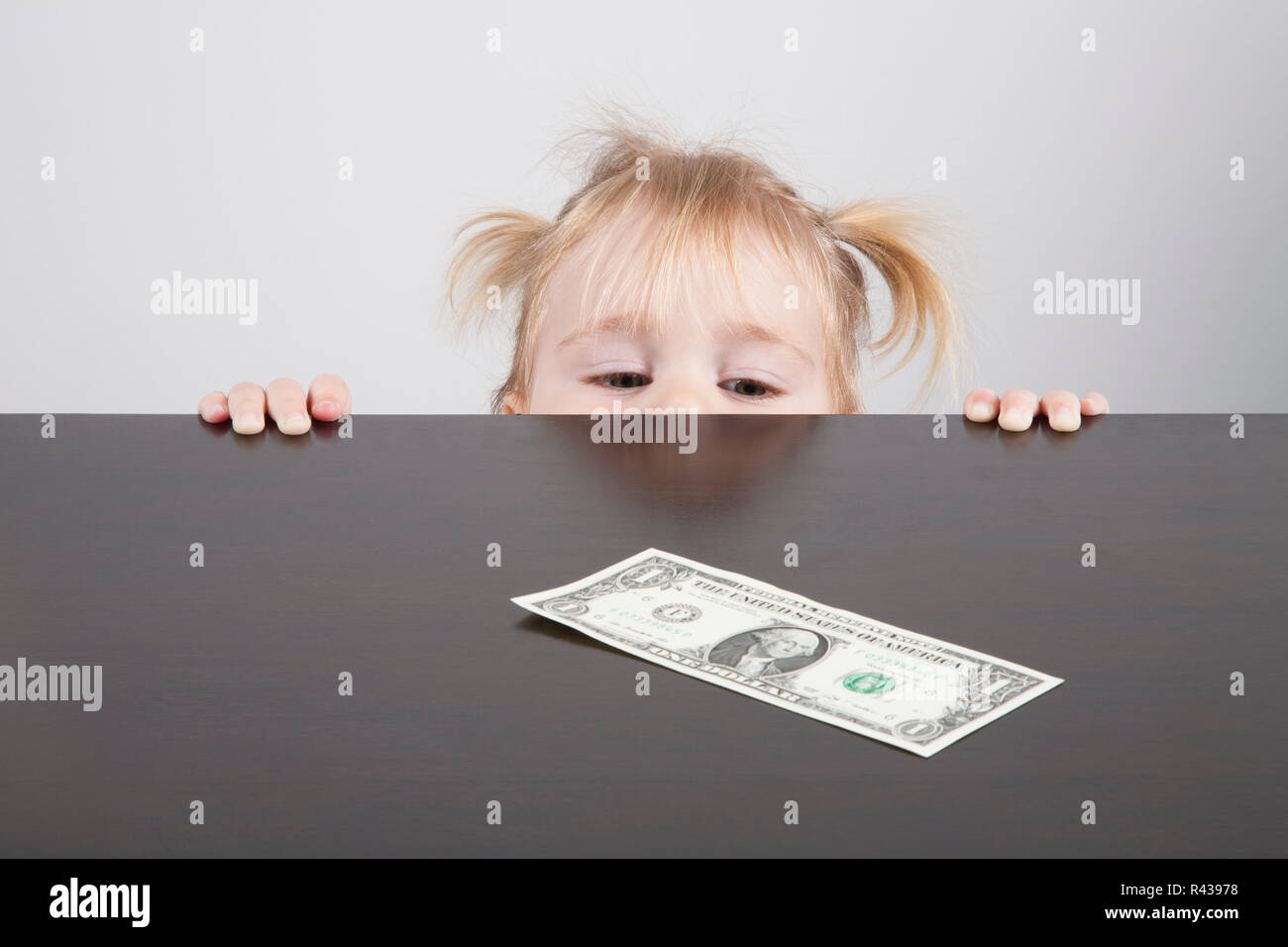 baby looking at dollar banknote horizontal Stock Photo - Alamy