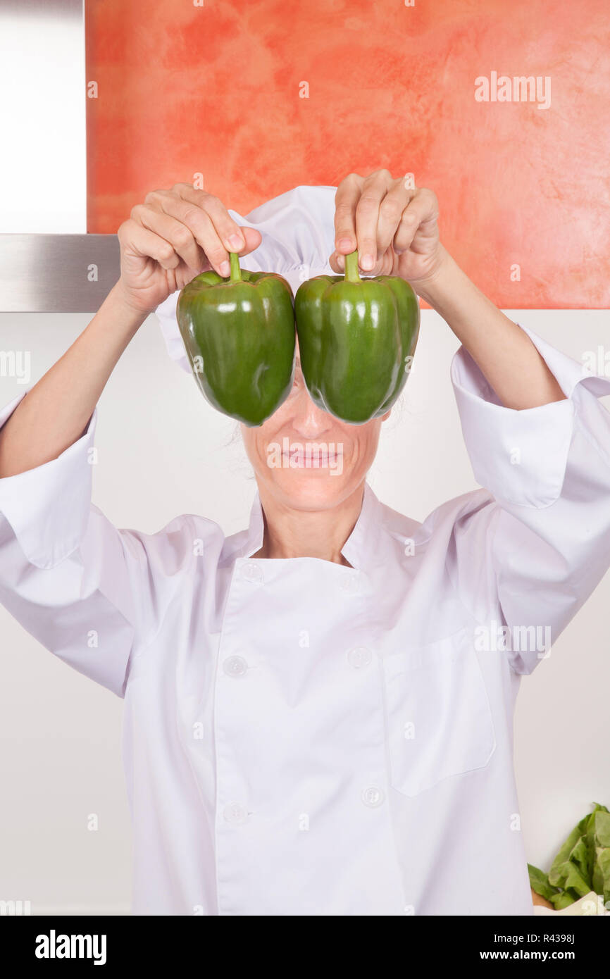 woman chef with two peppers eyes Stock Photo - Alamy