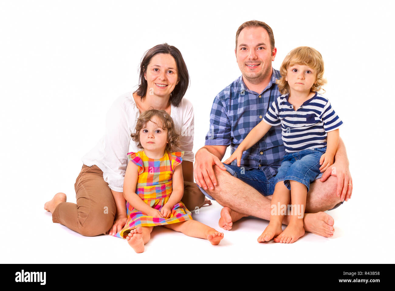 Happy family of four smiling Stock Photo - Alamy