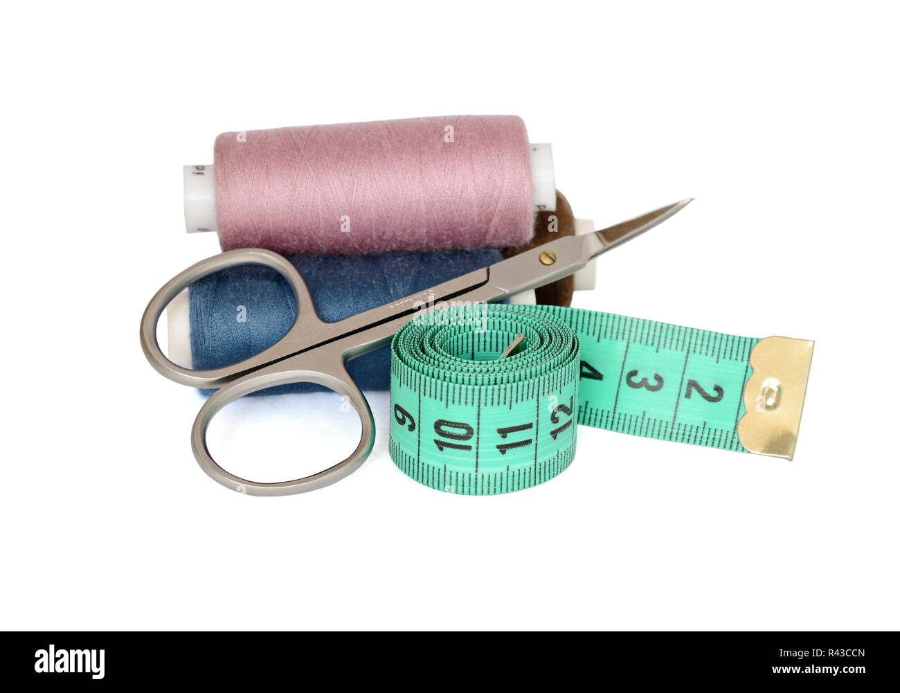 Thread, scissors and measuring tape isolated on white background Stock ...
