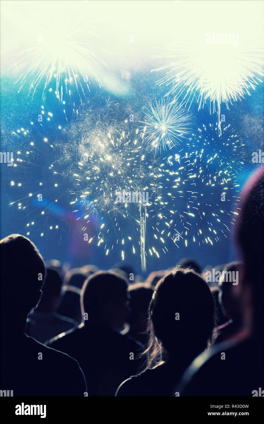 New Year concept - cheering crowd and fireworks Stock Photo - Alamy