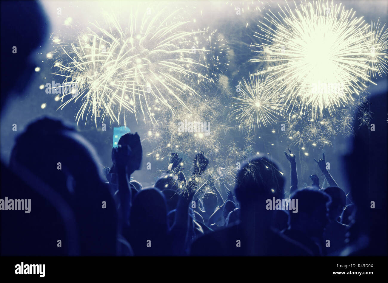 New Year concept - cheering crowd and fireworks Stock Photo - Alamy