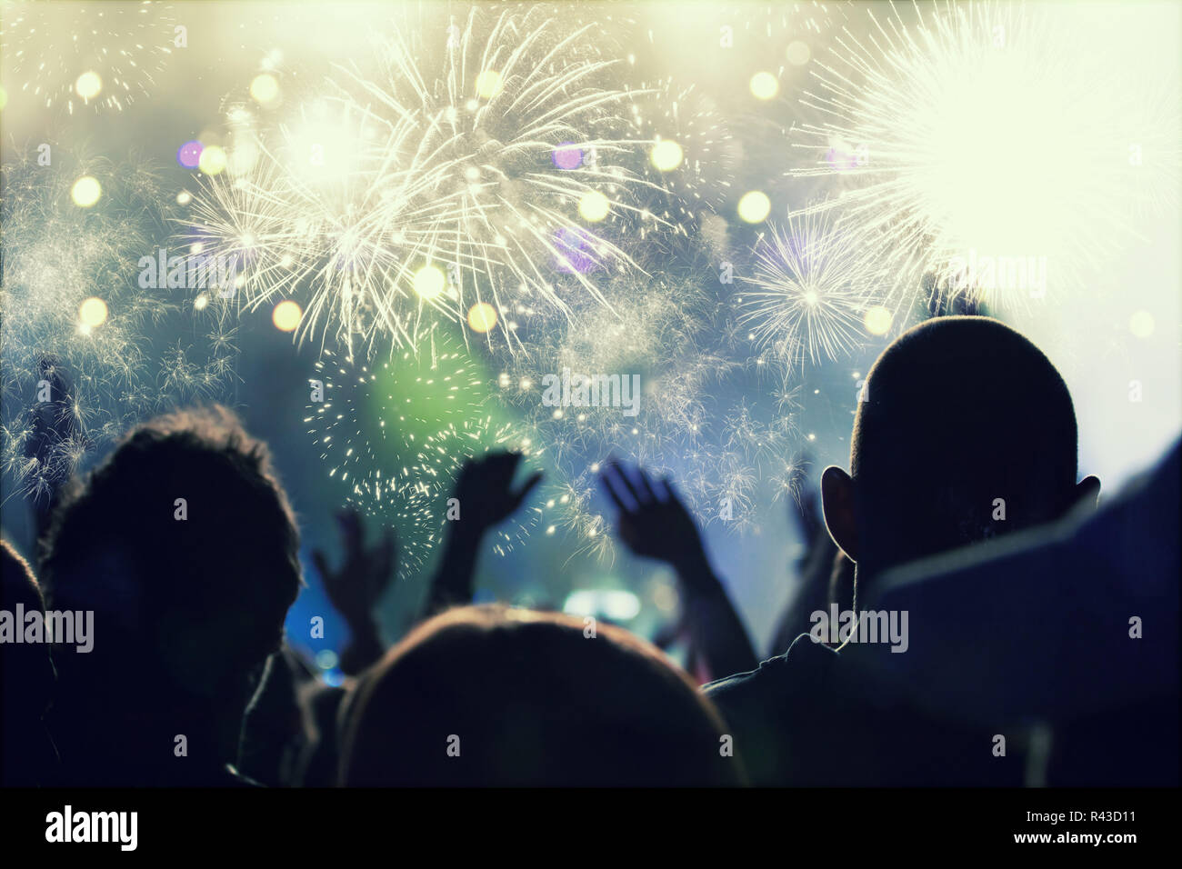 New Year concept - cheering crowd and fireworks Stock Photo - Alamy