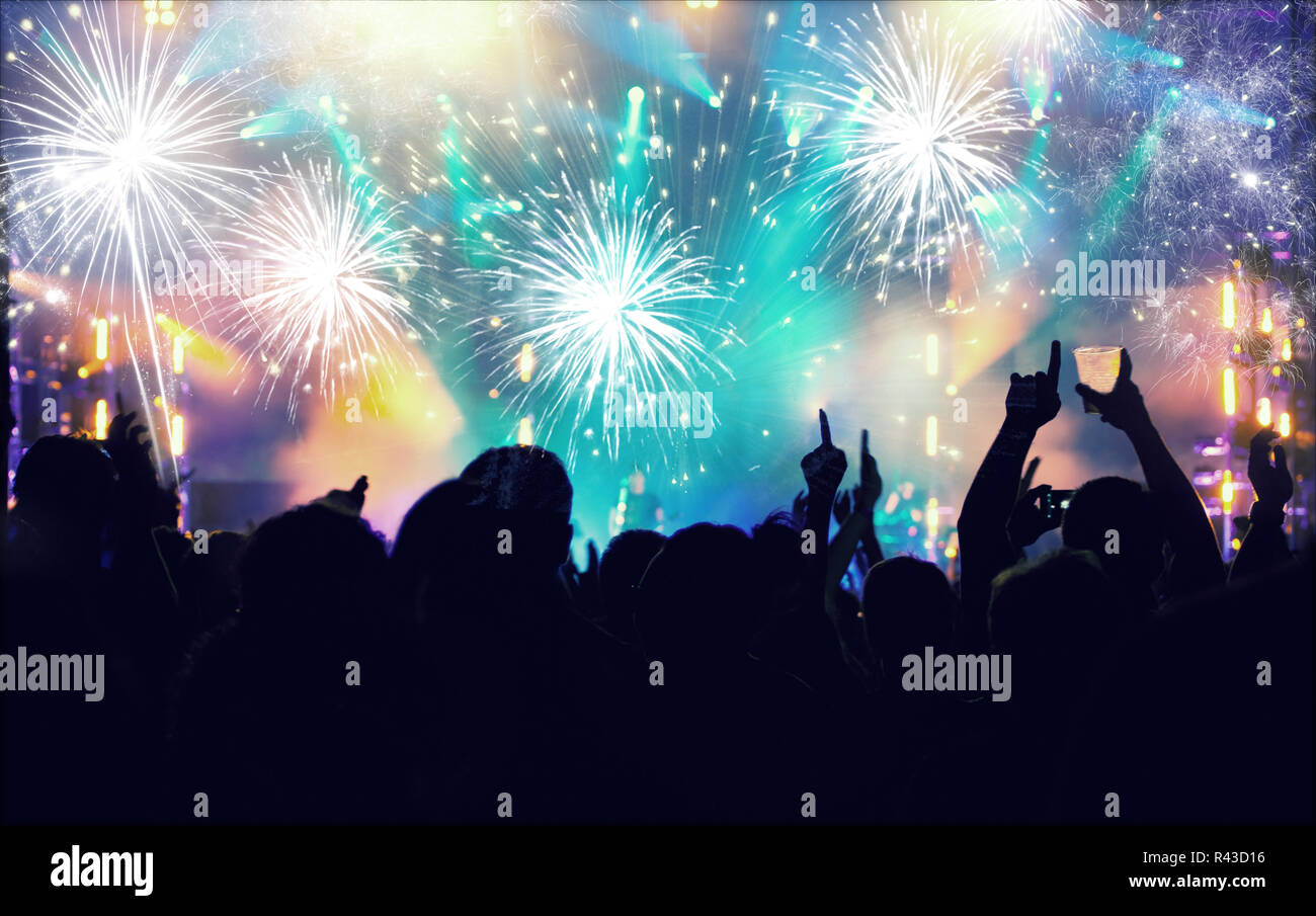 New Year concept - cheering crowd and fireworks Stock Photo - Alamy