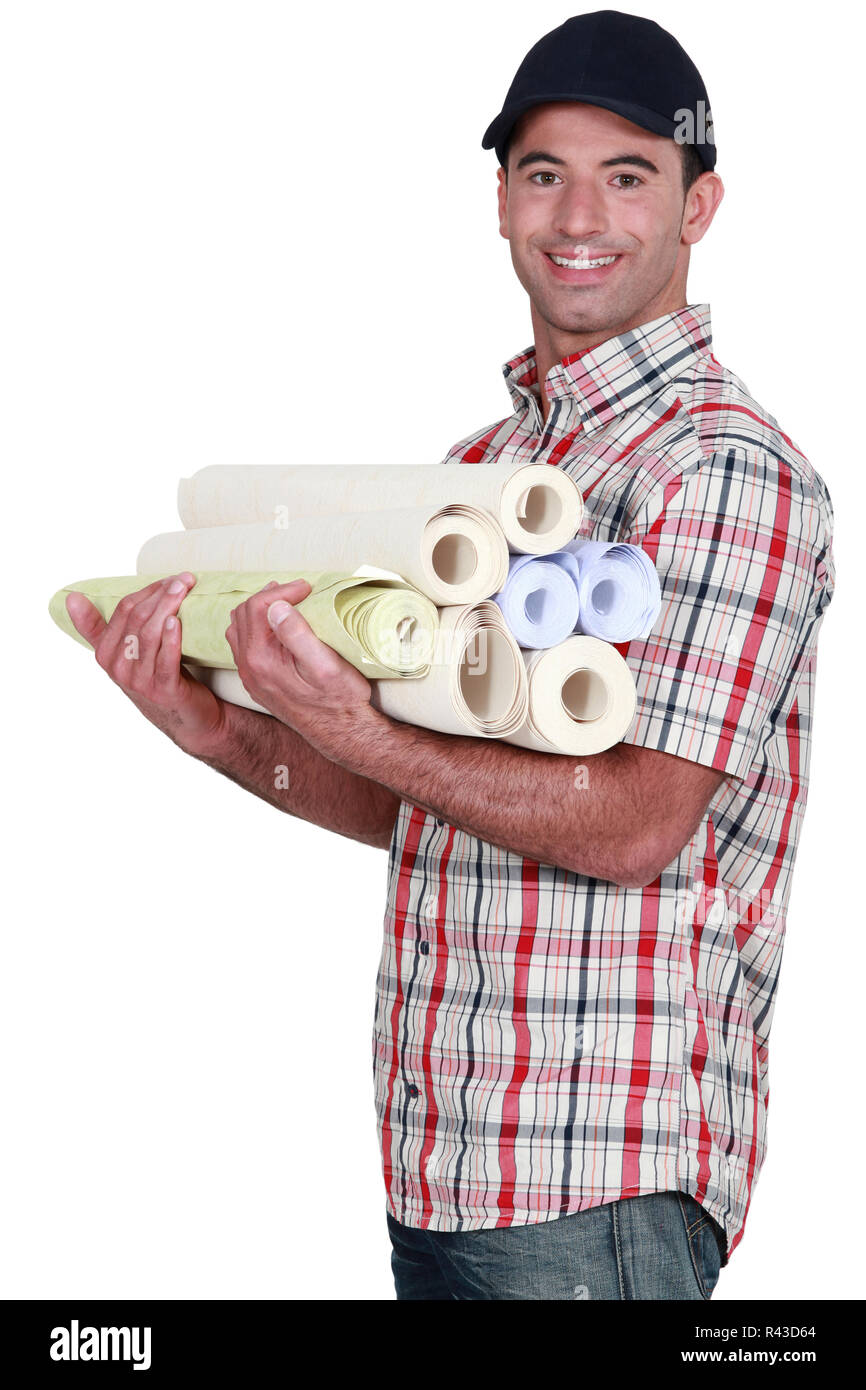 Man carrying rolls of wall-paper Stock Photo - Alamy