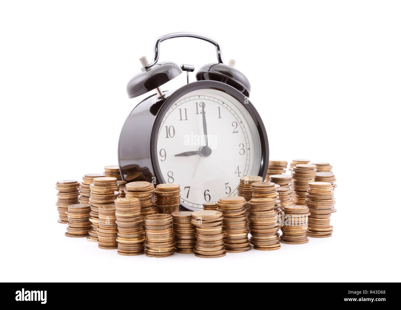 Time is money. Alarm clock with stacks of coins. Clipping path included ...