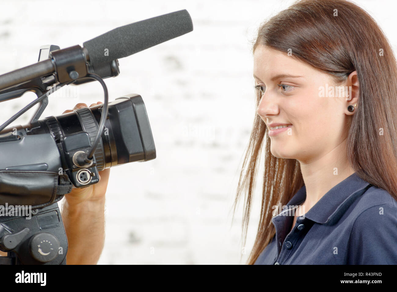 a young woman journalist looks at the camera Stock Photo - Alamy