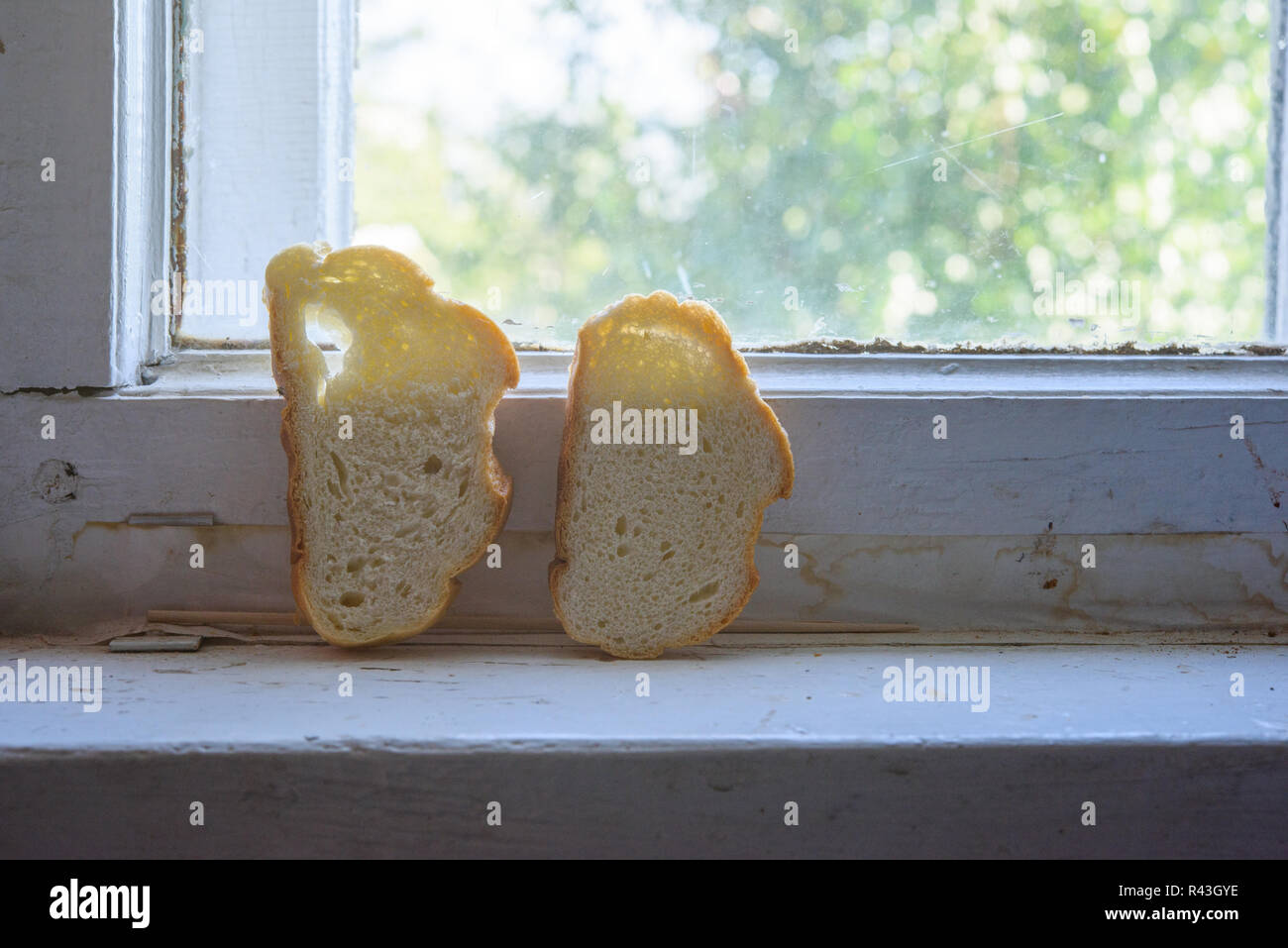 Two sad bread slices at rustic village white windowsill Stock Photo - Alamy