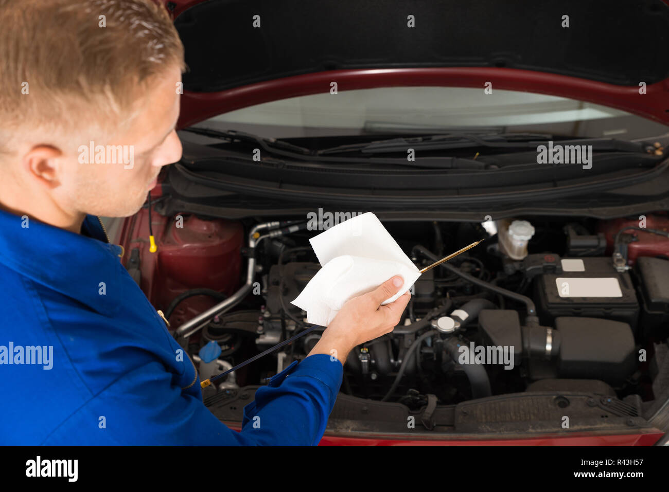 Mechanic Checking Oil Level In Car Engine Stock Photo - Alamy