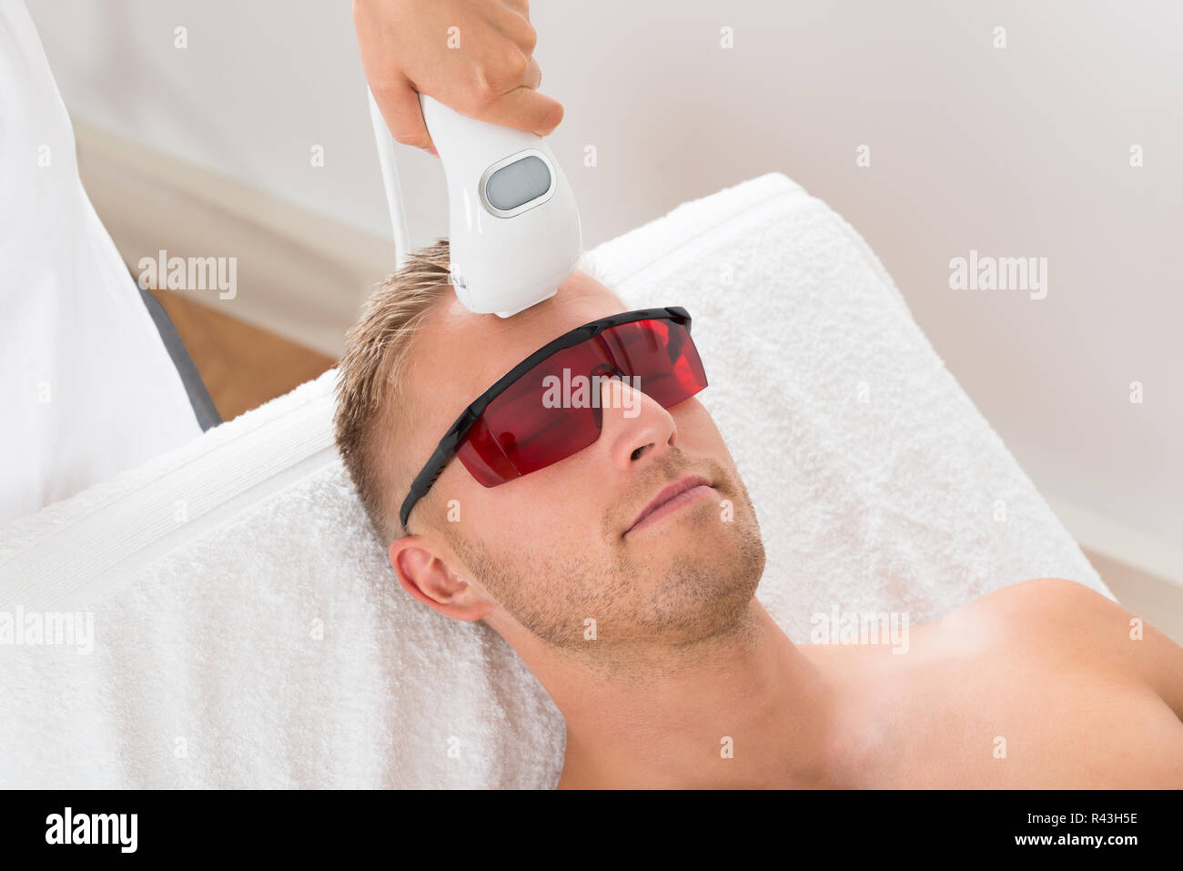 Beautician Giving Laser Epilation Treatment Stock Photo - Alamy