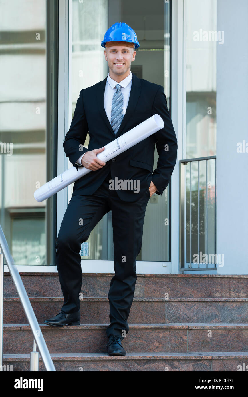 Architect Holding Blueprint In His Hand Stock Photo - Alamy