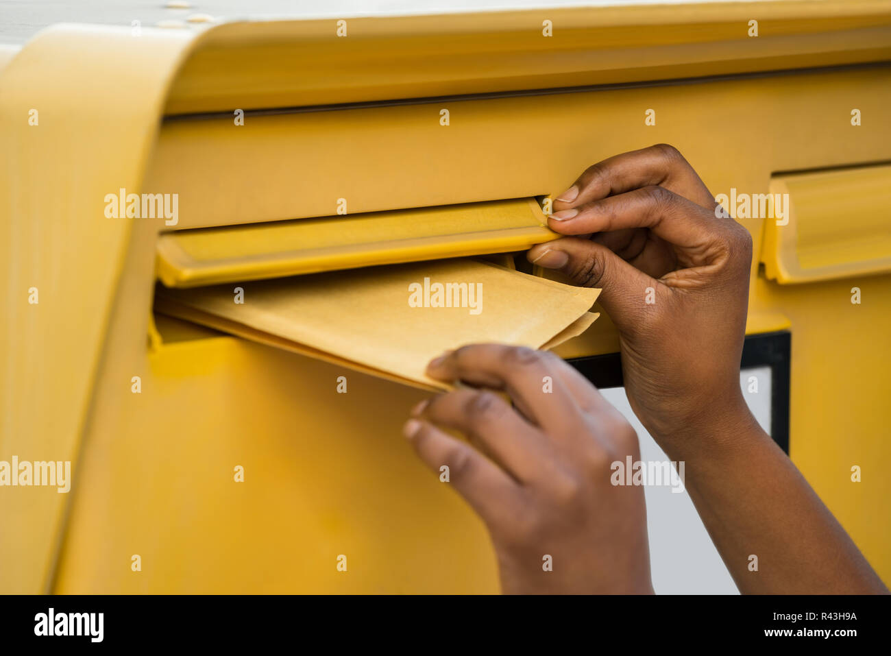 Person's Hand Inserting Letter In Mailbox Stock Photo - Alamy