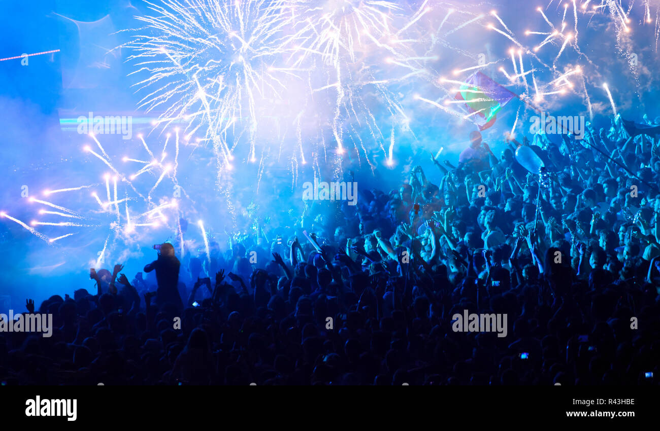 Crowd celebrating with fireworks Stock Photo - Alamy