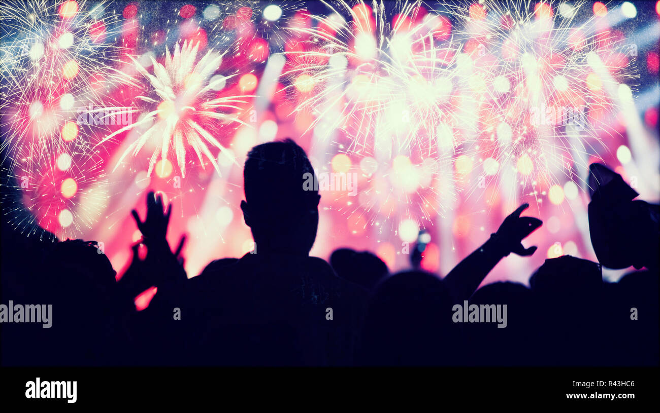 Crowd celebrating with fireworks Stock Photo - Alamy