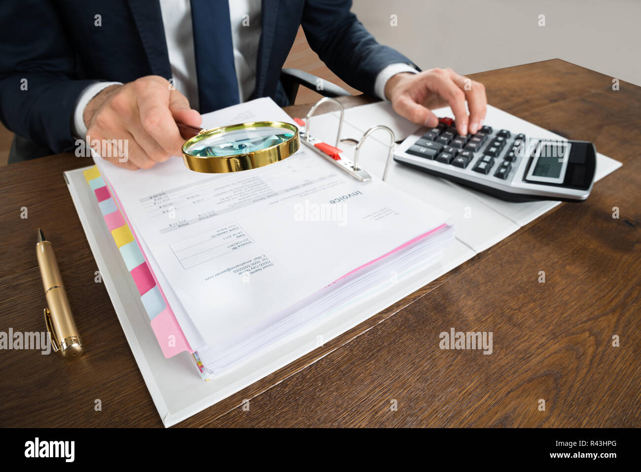 Businessman Checking Invoice With Magnifying Glass Stock Photo - Alamy