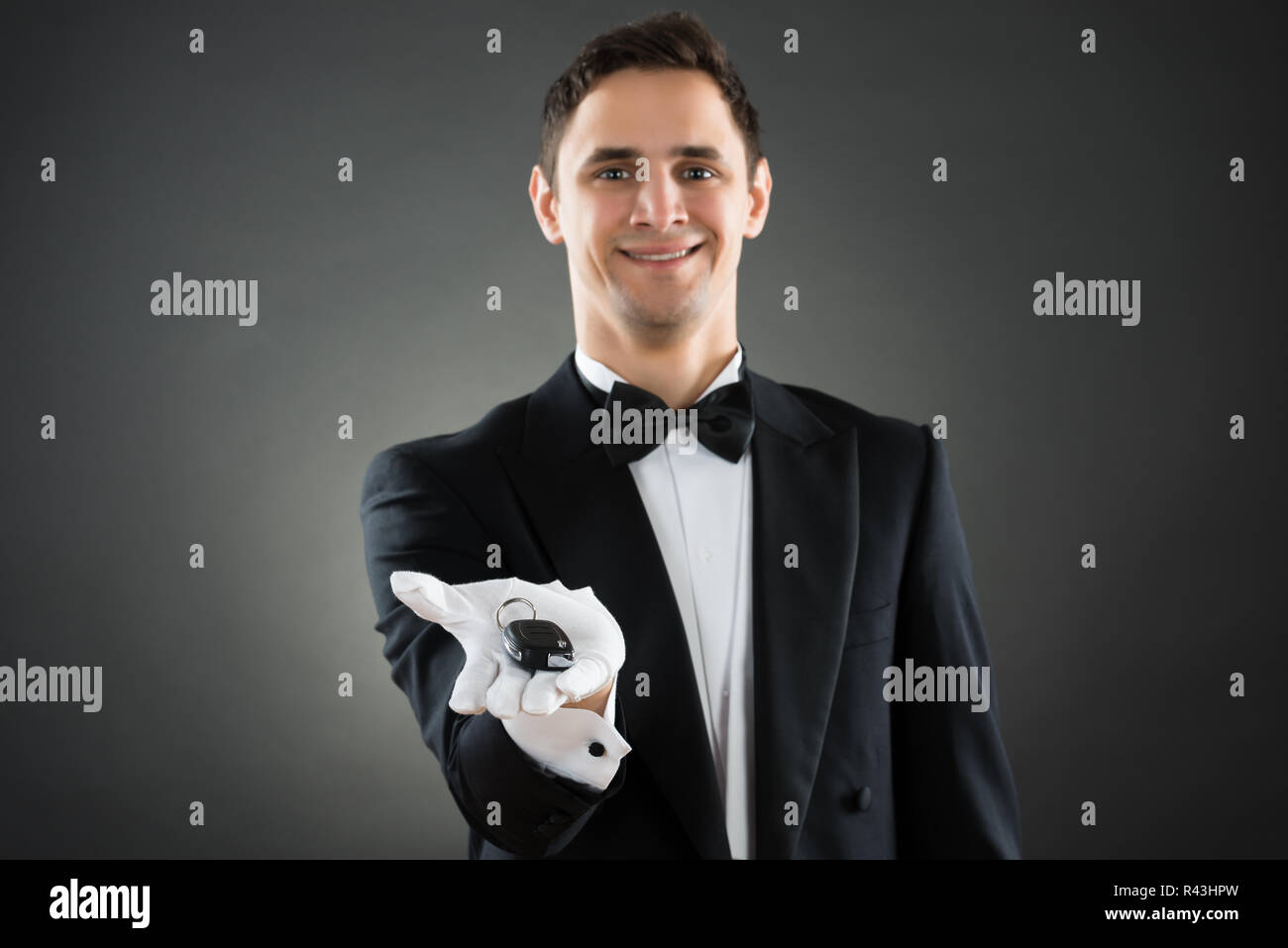 Portrait Of Happy Waiter Giving Car Keys Stock Photo - Alamy