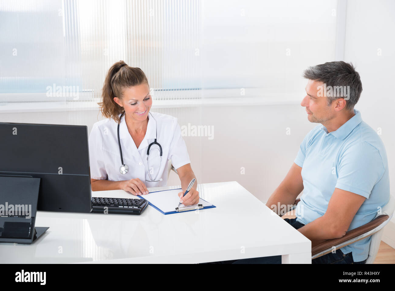 Female Doctor Talking With Patient In Hospital Stock Photo - Alamy