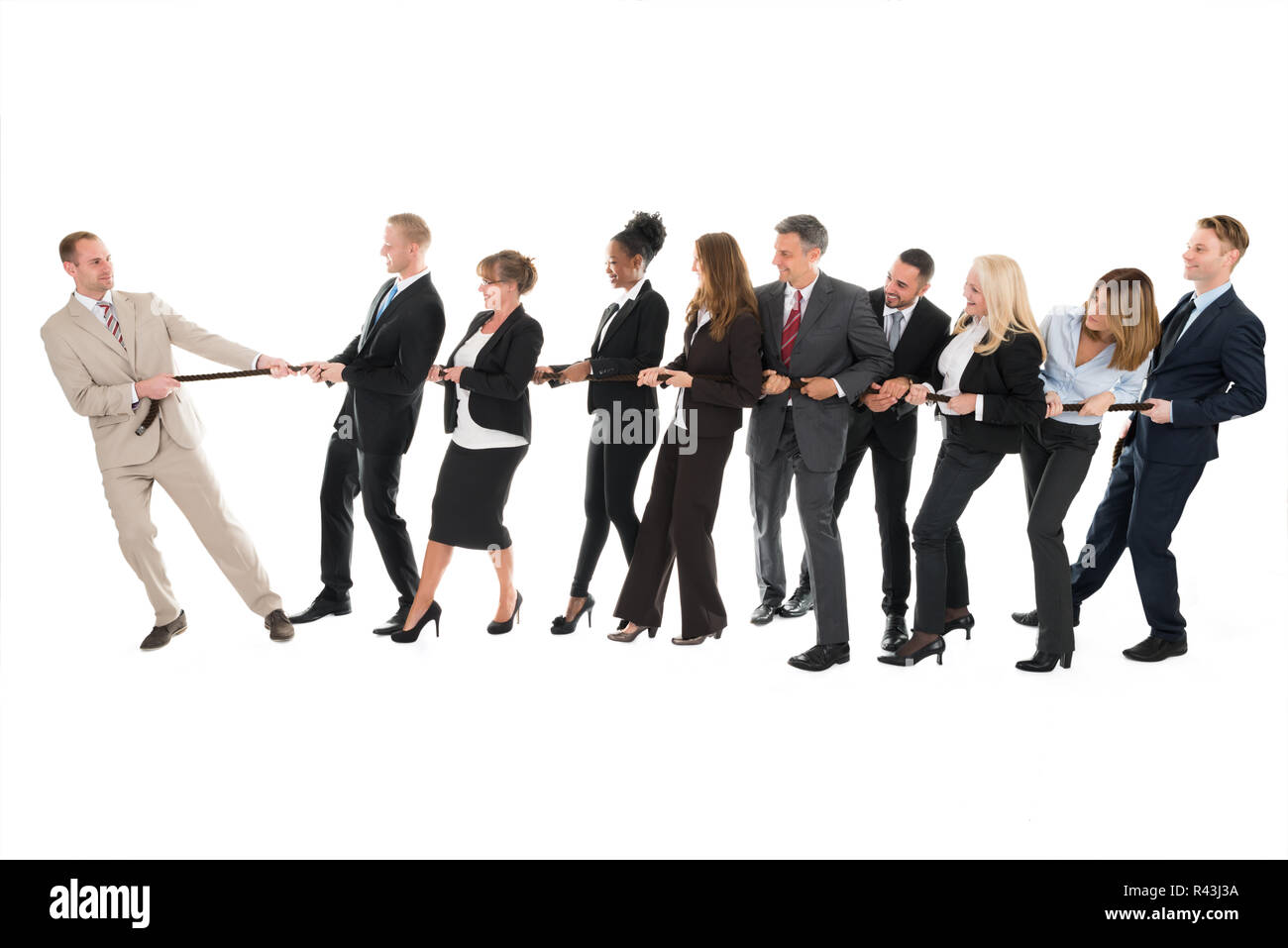 Leader Pulling Business Team While Playing Tug Of War Stock Photo - Alamy