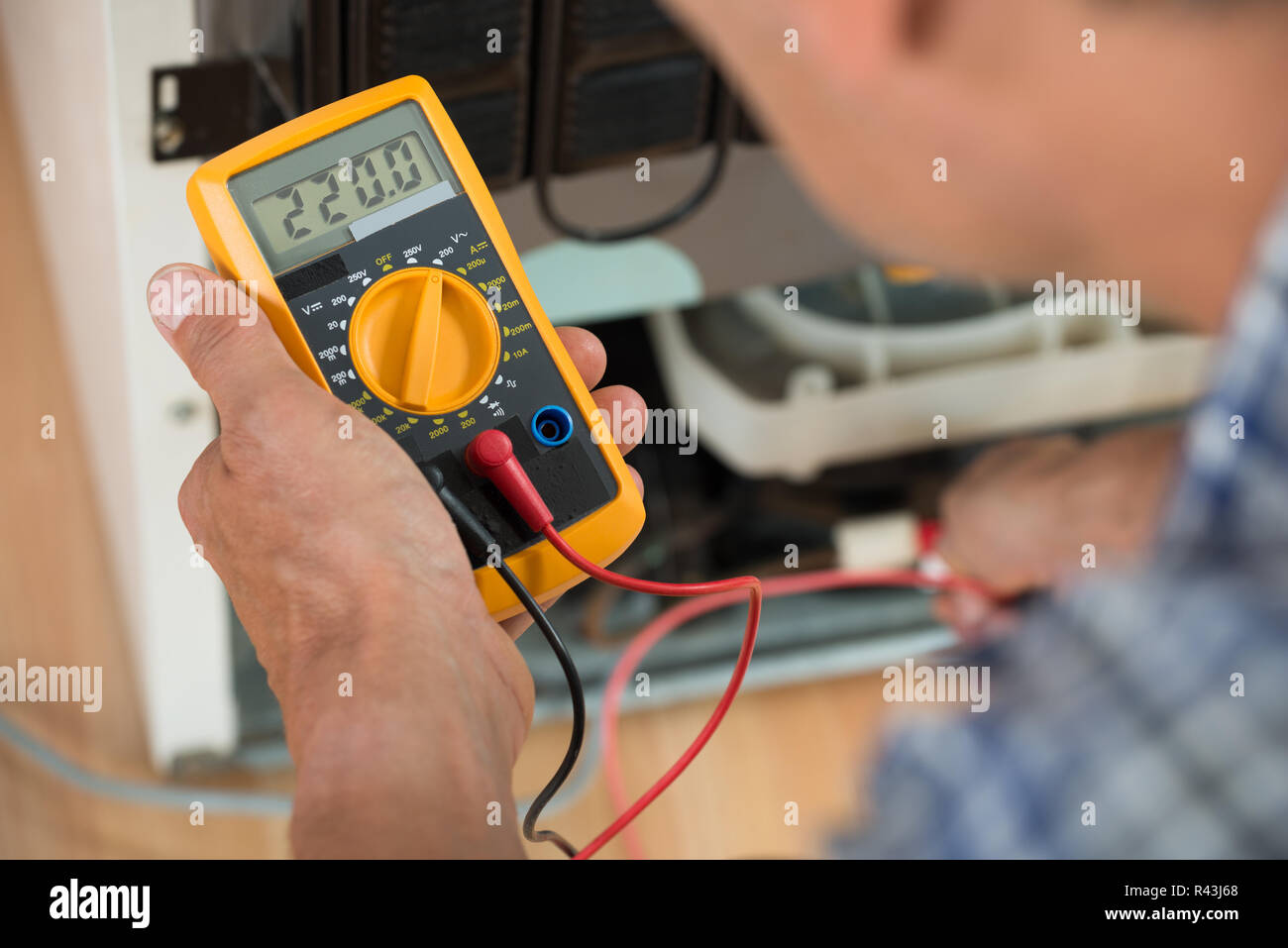 Repairman Checking Fridge With Digital Multimeter Stock Photo - Alamy