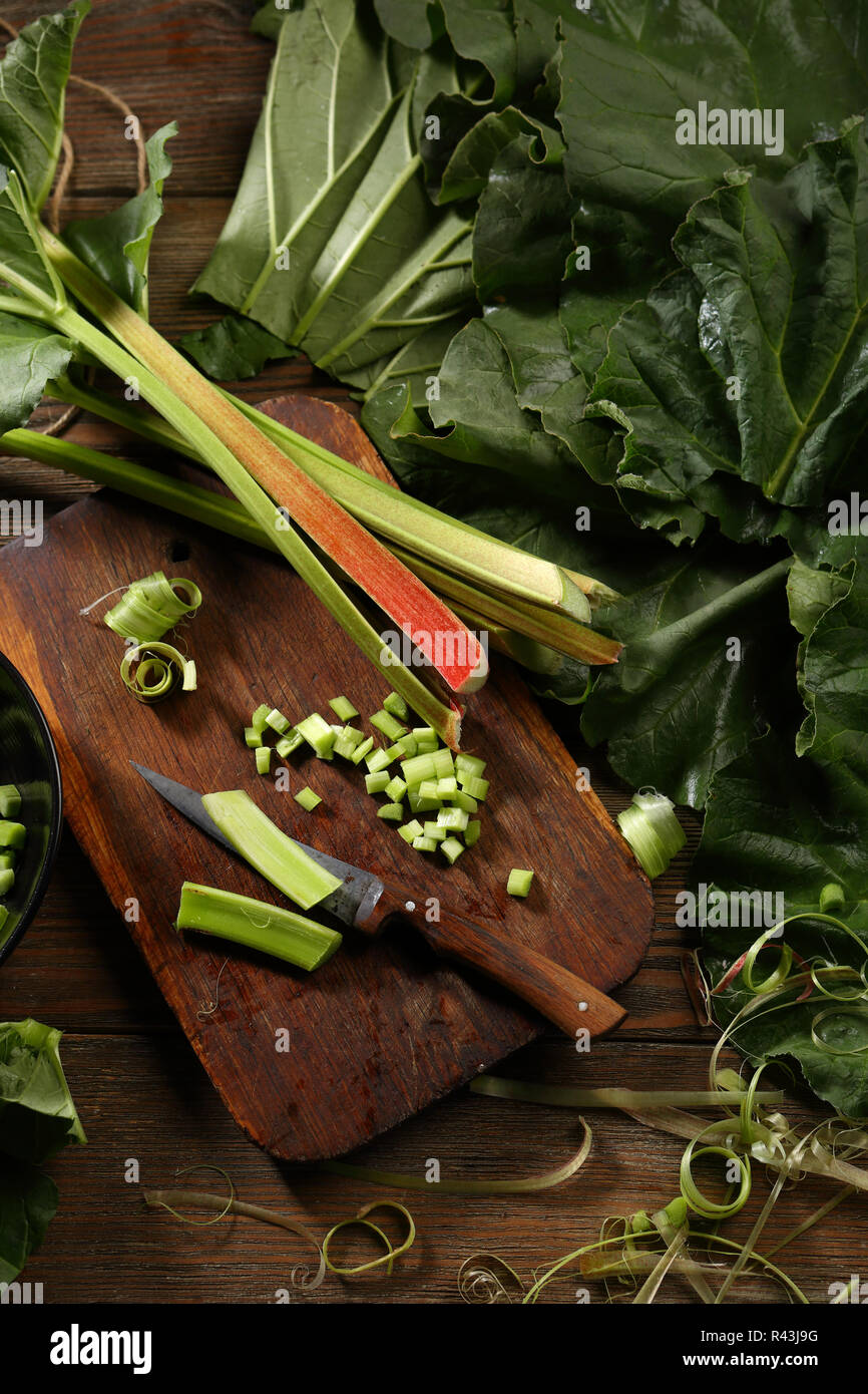 Cutting fresh rhubarb on wood board Stock Photo - Alamy