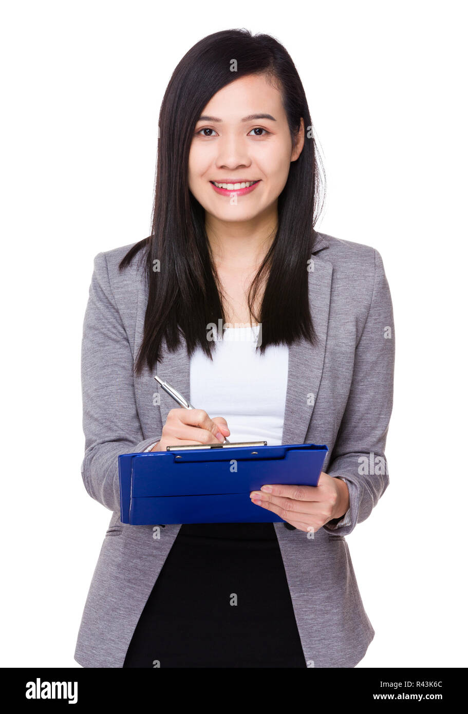 Young Businesswoman take note on clipboard Stock Photo - Alamy