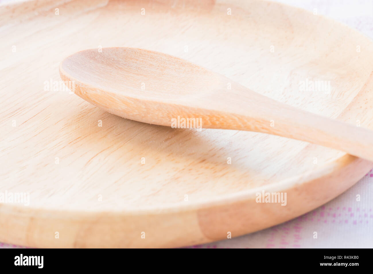 Set of wooden spoon and plate Stock Photo - Alamy