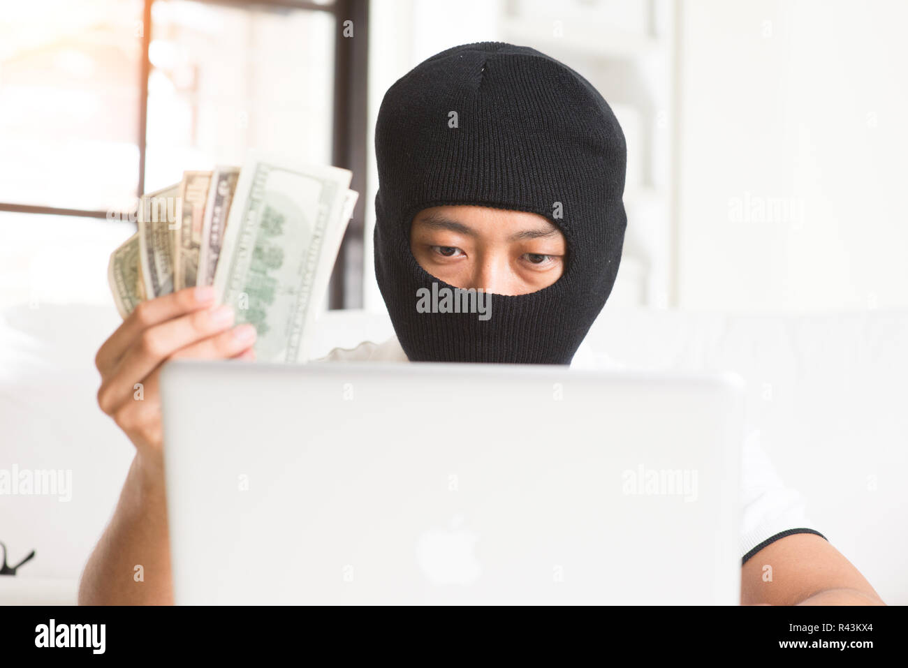 hacker and cash Stock Photo - Alamy