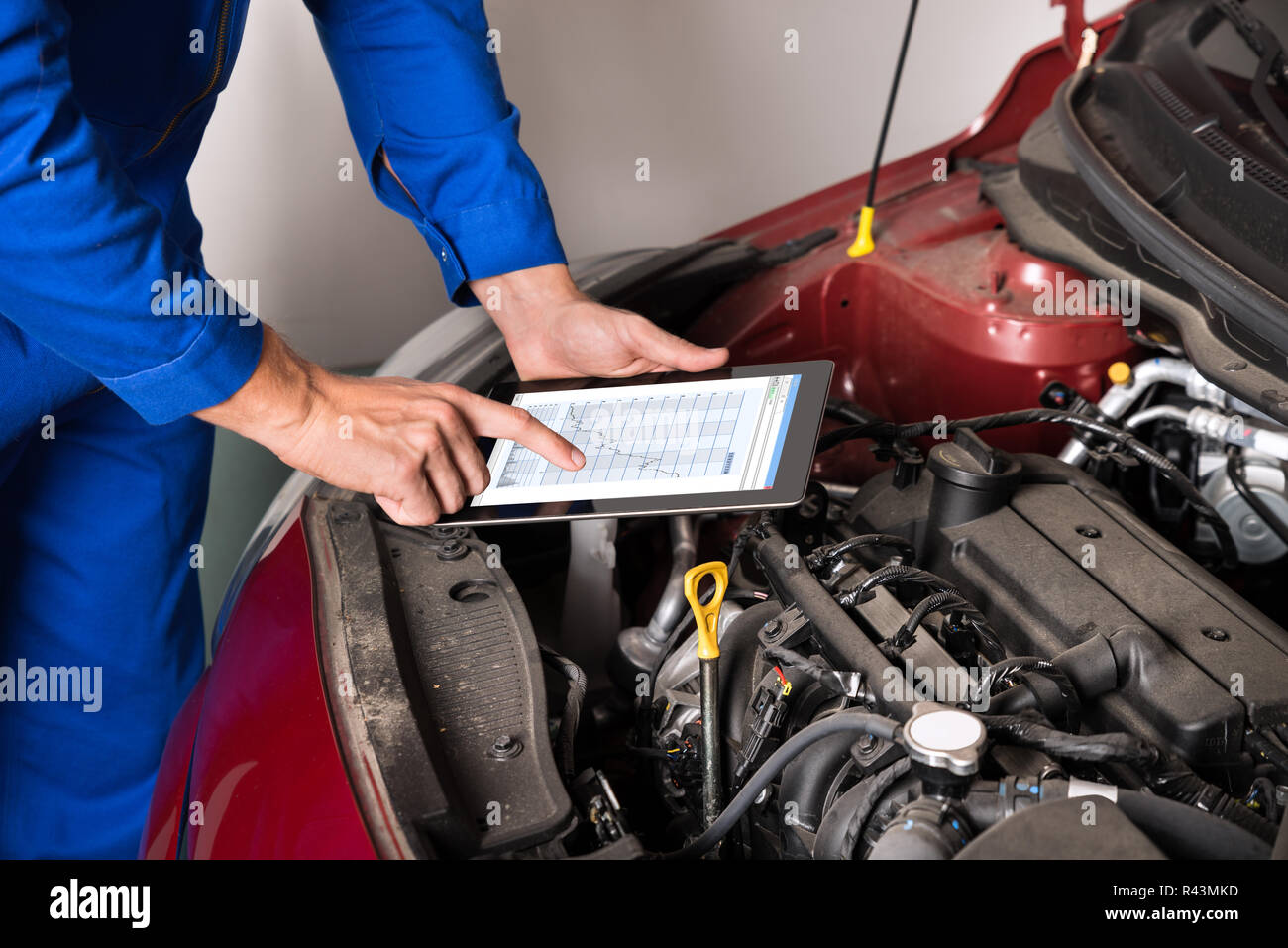 Mechanic Using Digital Tablet While Examining Car Engine Stock Photo ...