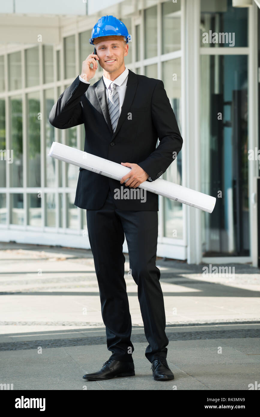 Cheerful handsome engineer holding copy hi-res stock photography and ...