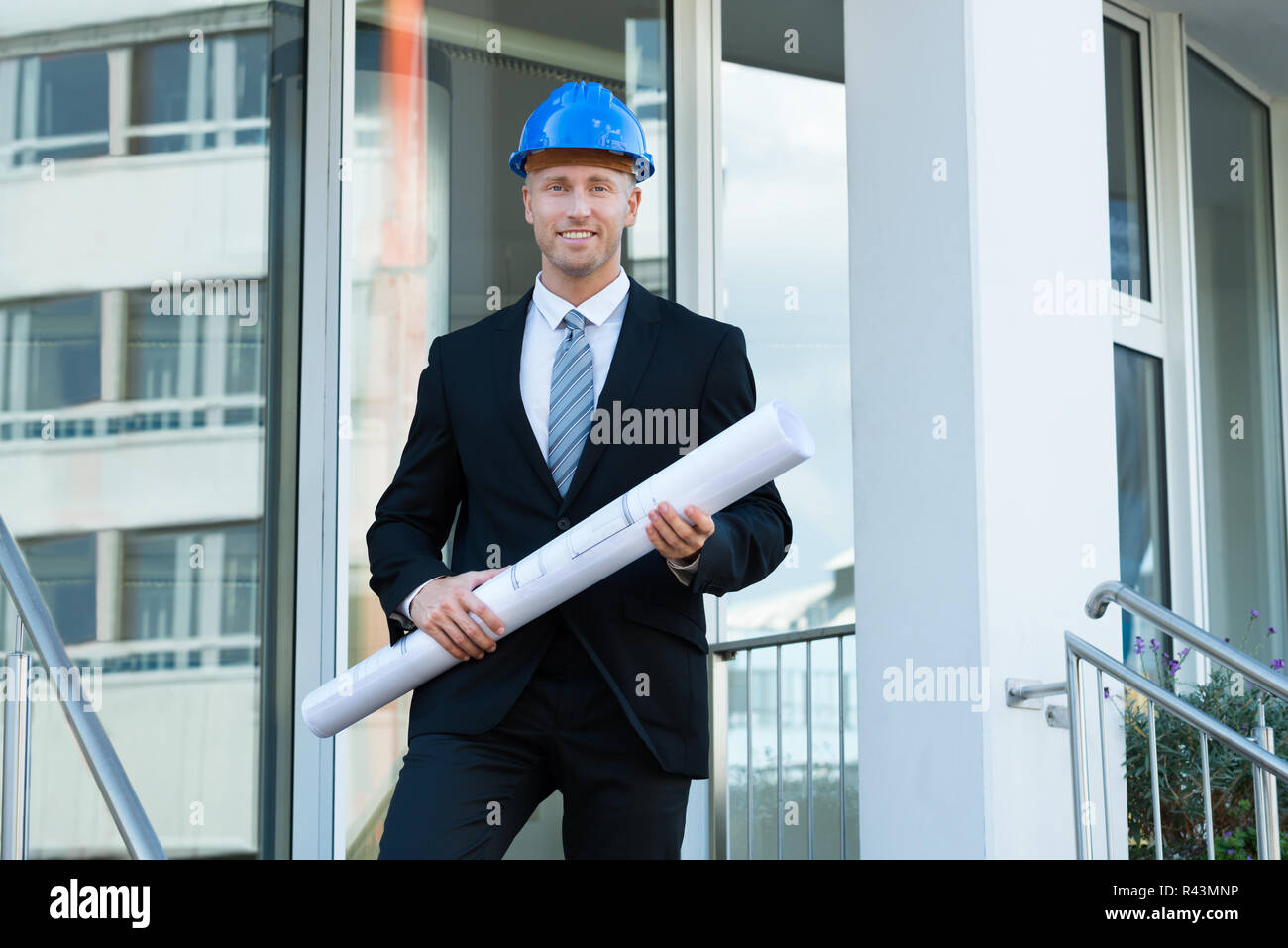 Architect Holding Blueprint In His Hand Stock Photo - Alamy