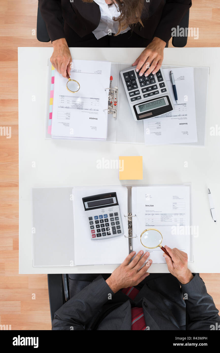 Two Businesspeople Inspecting Financial Expenses Stock Photo - Alamy