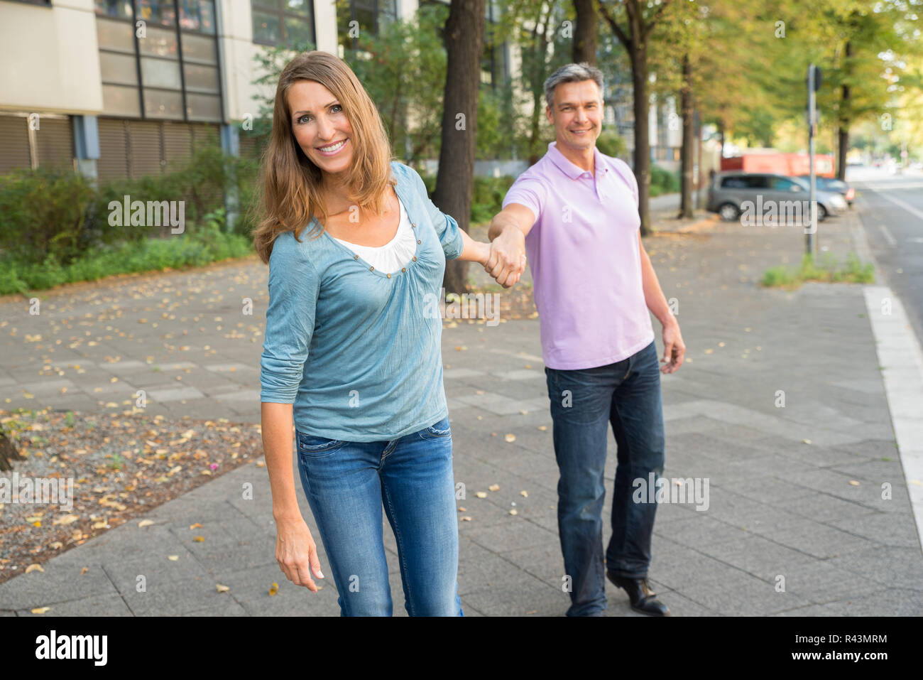 Man Pulling Woman In The Street Stock Photo - Alamy