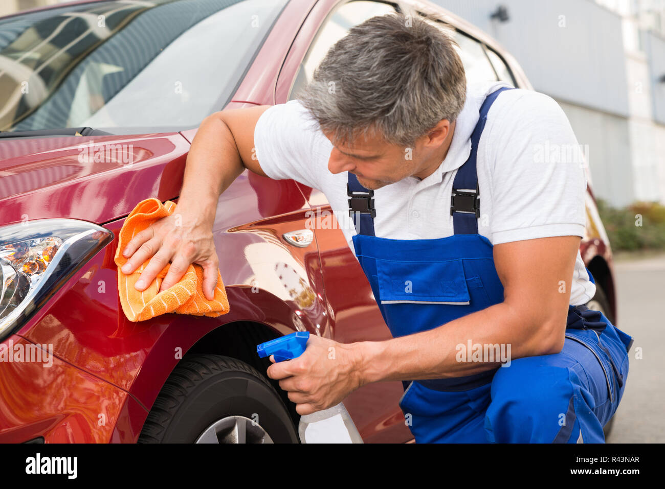 Male Worker Cleaning Red Car Stock Photo - Alamy