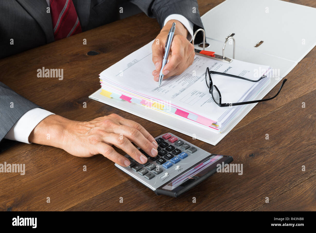 Accountant Checking Invoice With Calculator Stock Photo - Alamy