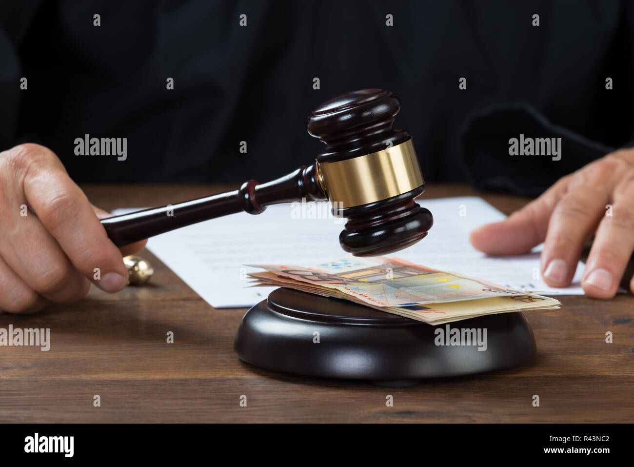 Judge Holding Gavel Over Banknotes At Desk Stock Photo - Alamy