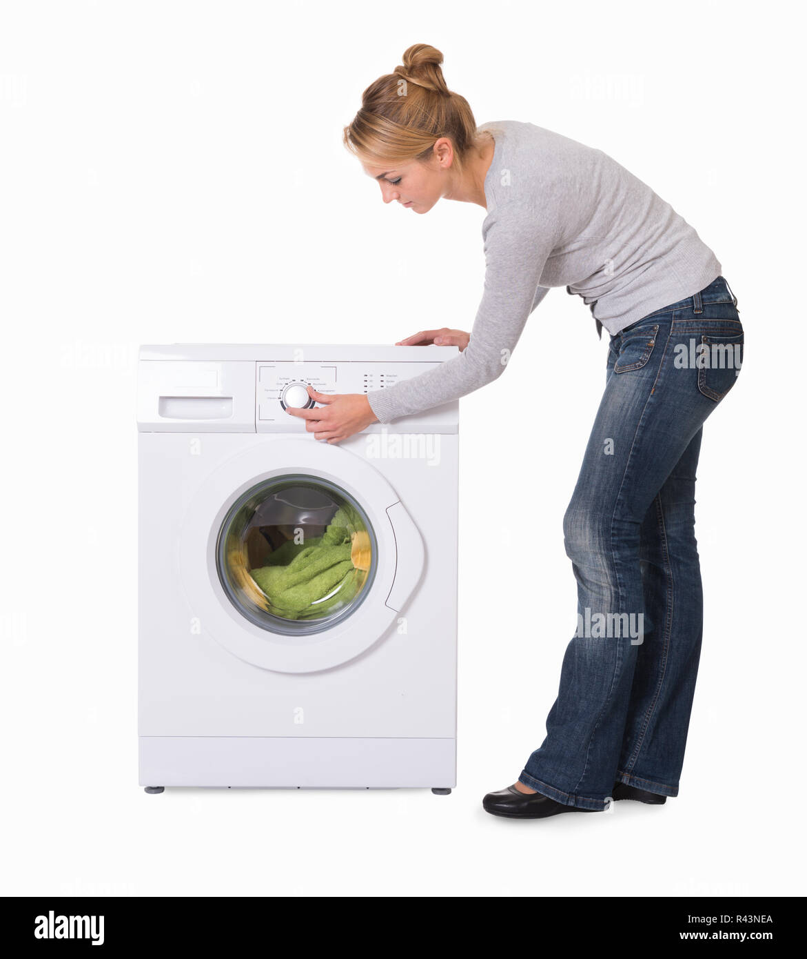 Woman Using Washing Machine Over White Background Stock Photo - Alamy