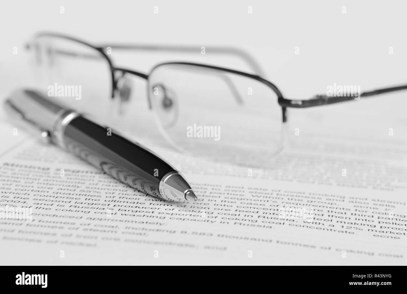 Pen and glasses on paper Stock Photo - Alamy