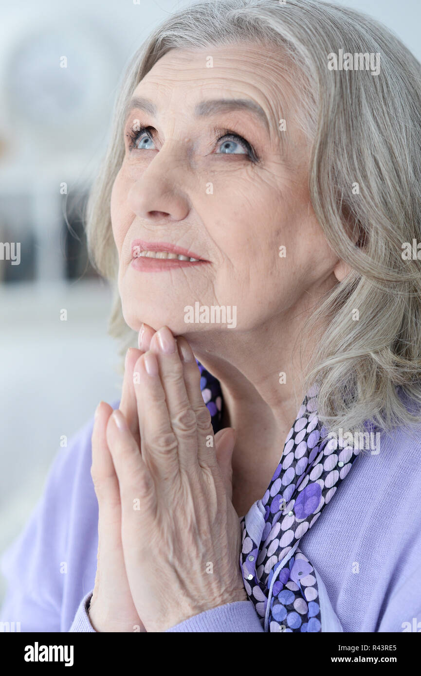 Elderly lady praying hi-res stock photography and images - Alamy