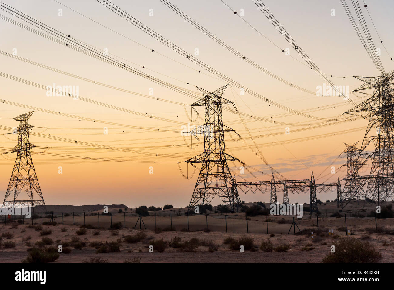 Electricity overhead power lines in the desert at sunset Stock Photo ...